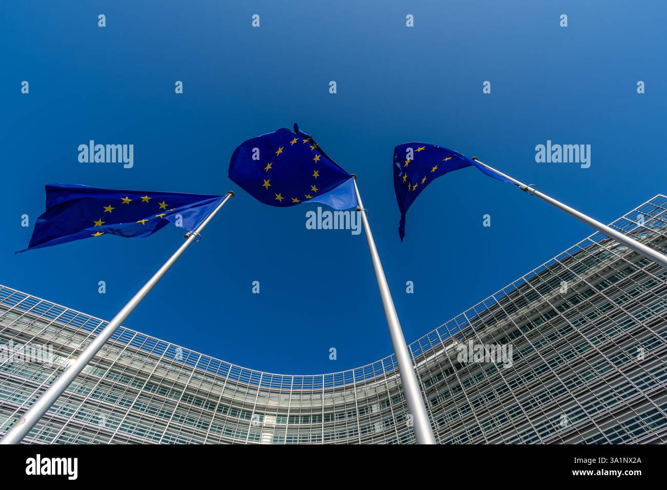 Three European flags, symbols of the European Union (EU), fluttering ...