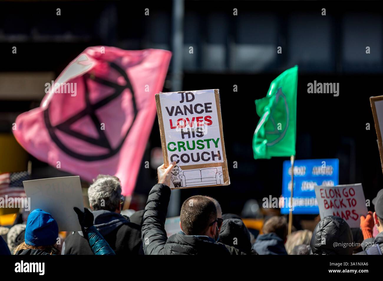 NEW YORK, NEW YORK - MARCH 8: A protestor outside a Tesla showroom in ...