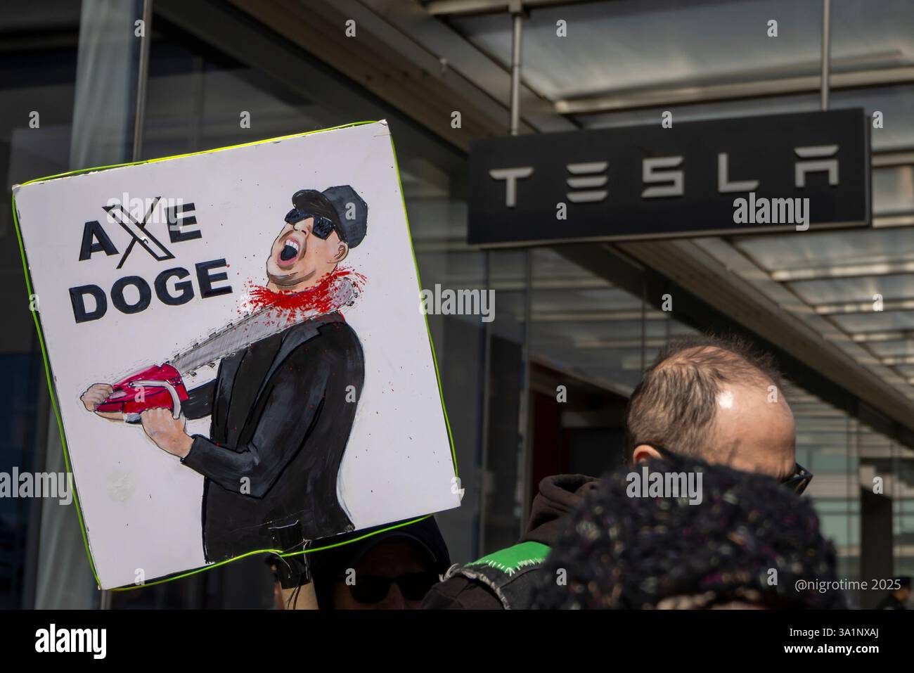 NEW YORK, NEW YORK - MARCH 8: A protestor outside a Tesla showroom in ...