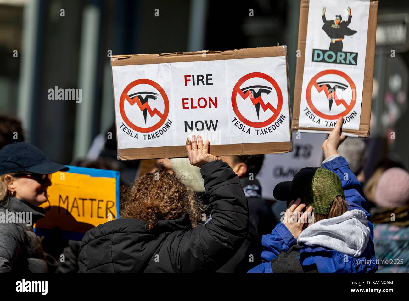 NEW YORK, NEW YORK - MARCH 8: A protestor outside a Tesla showroom in ...