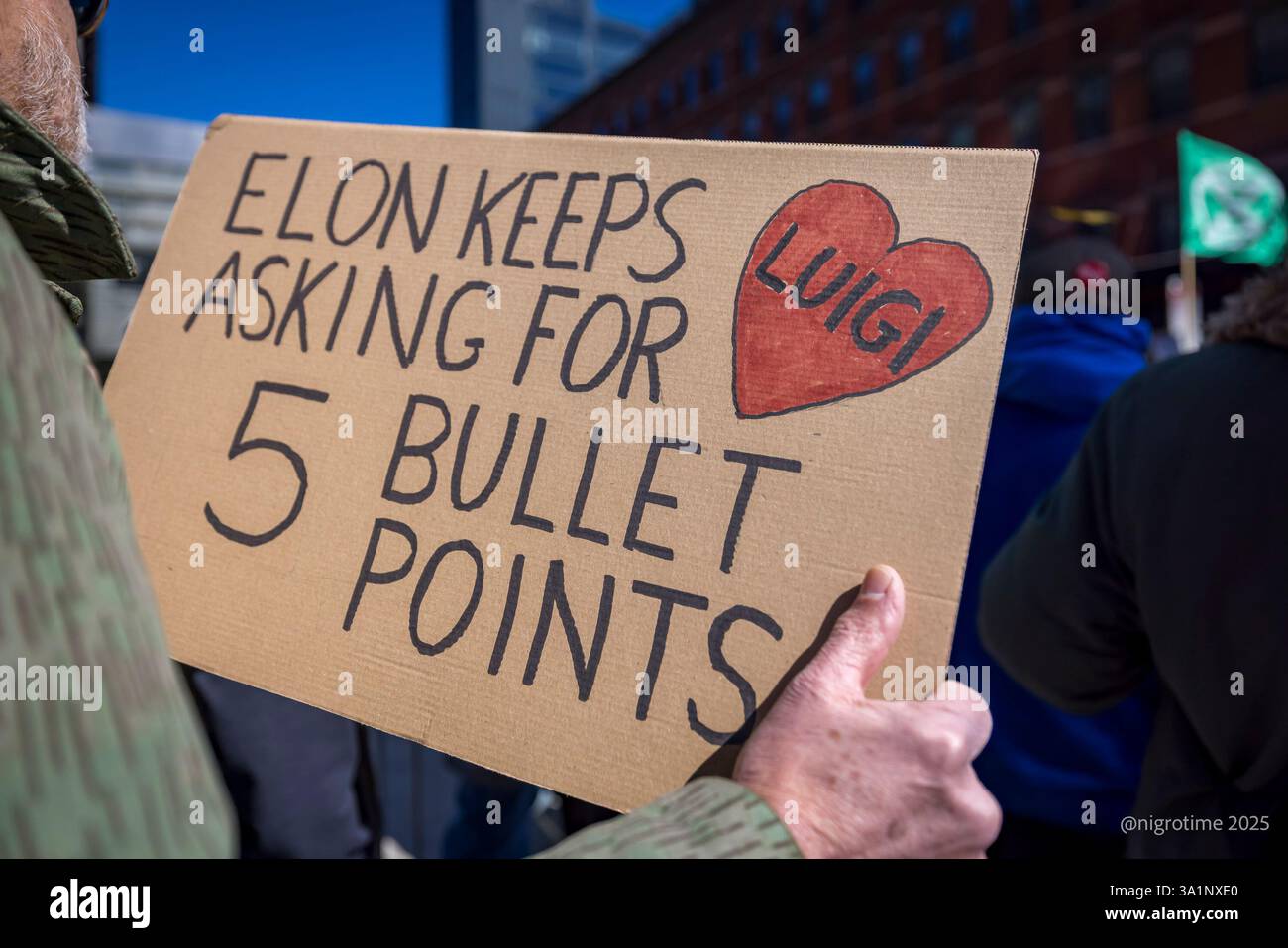 NEW YORK, NEW YORK - MARCH 8: A protestor outside a Tesla showroom in ...