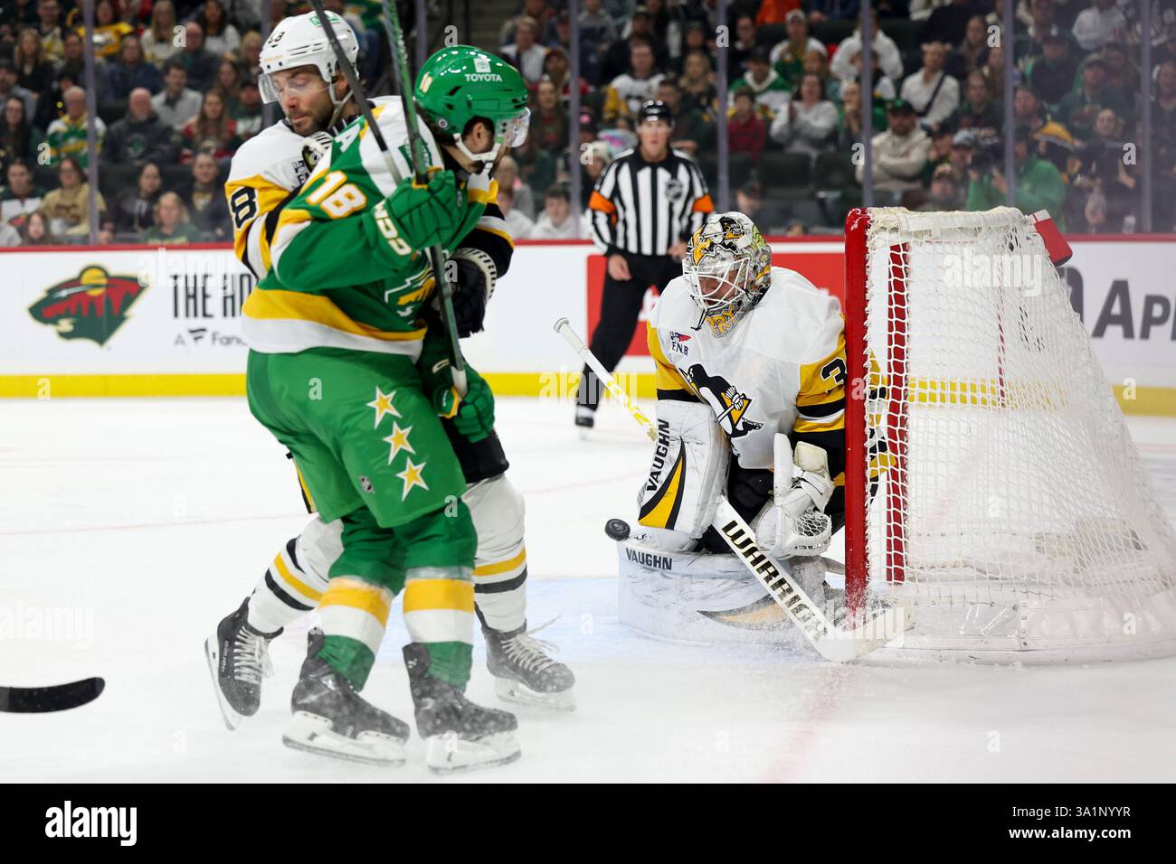 Pittsburgh Penguins goaltender Tristan Jarry, right, saves the puck ...
