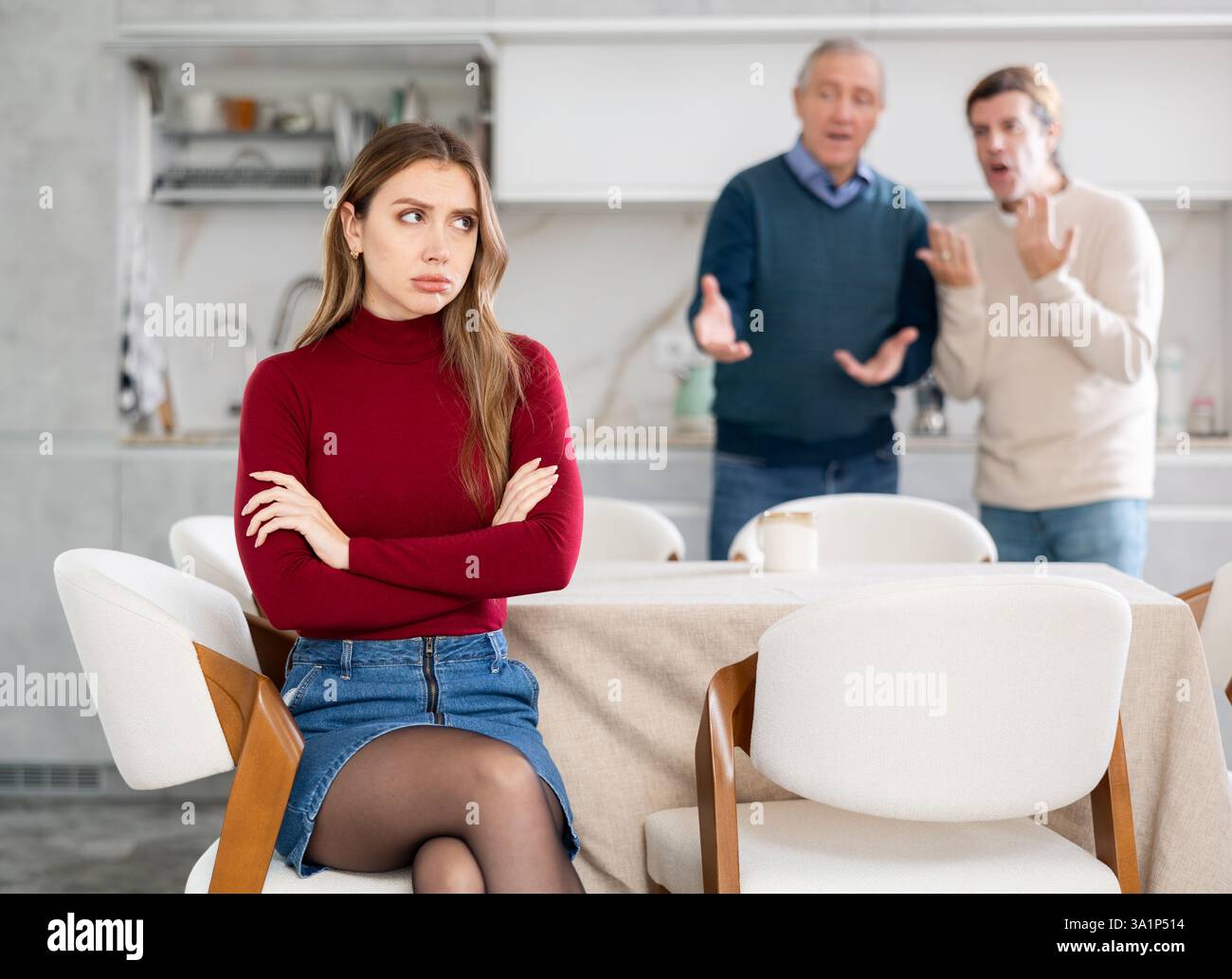 Two men quarreling with young woman Stock Photo - Alamy
