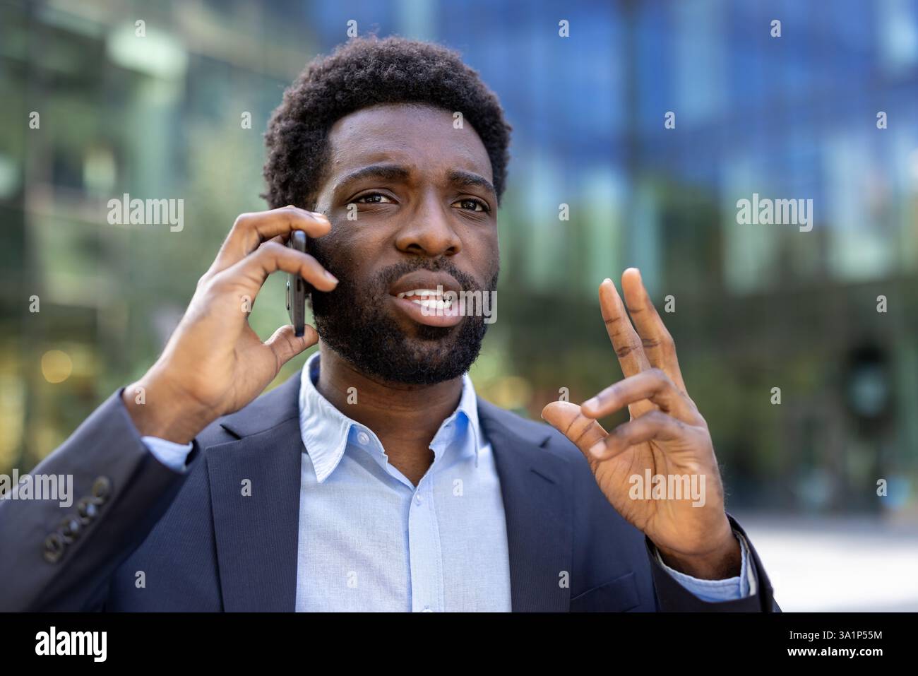 Serious worried man talking on mobile phone. Afro American man close up ...