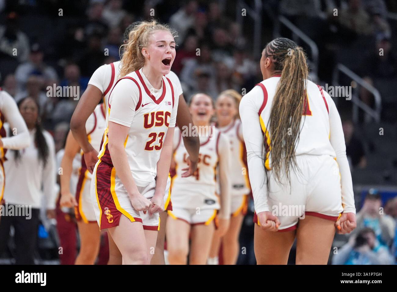 Southern California guard Avery Howell (23) reacts with teammates ...