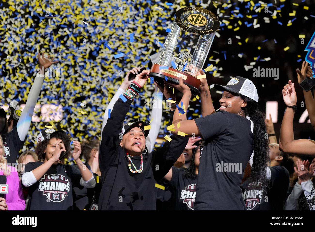 South Carolina head coach Dawn Staley holds the trophy with forward ...