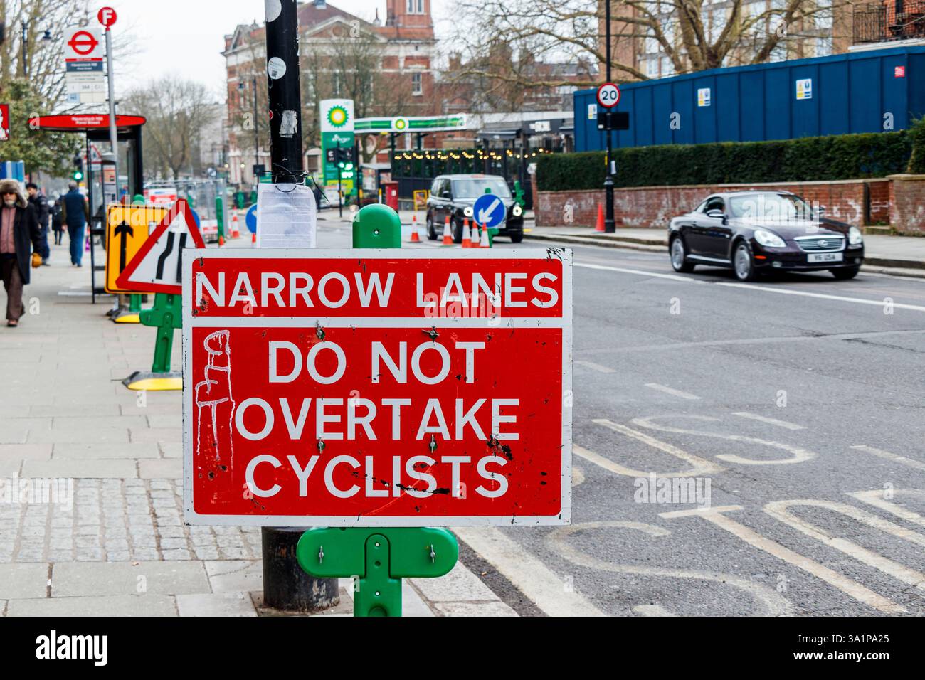 'Do Not Overtake Cyclists' sign next to roadworks on Haverstock Hill ...