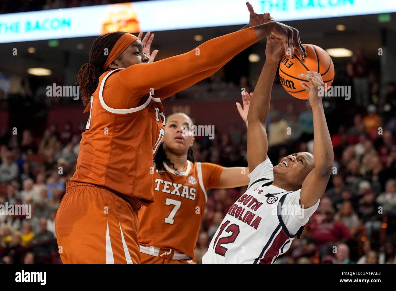 Texas forward Kyla Oldacre fouls South Carolina guard MiLaysia Fulwiley ...