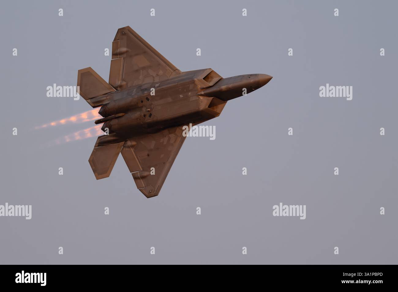 F-22 Raptor in Flight With Afterburners Illuminating Against Evening ...