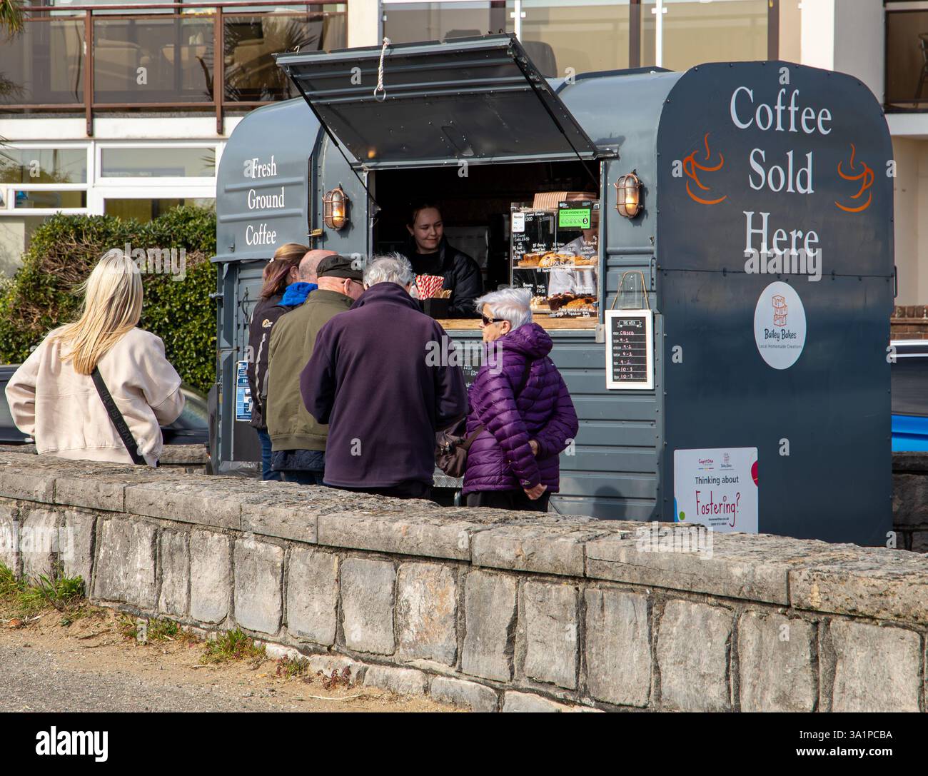 A group of people waiting at a coffee truck selling fresh ground coffee ...