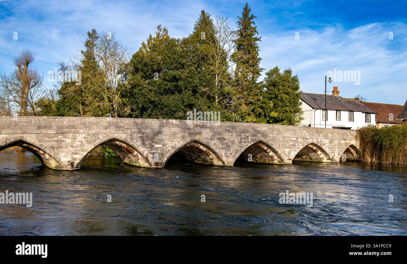 Historic stone medieval bridge with multiple arches over a flowing ...