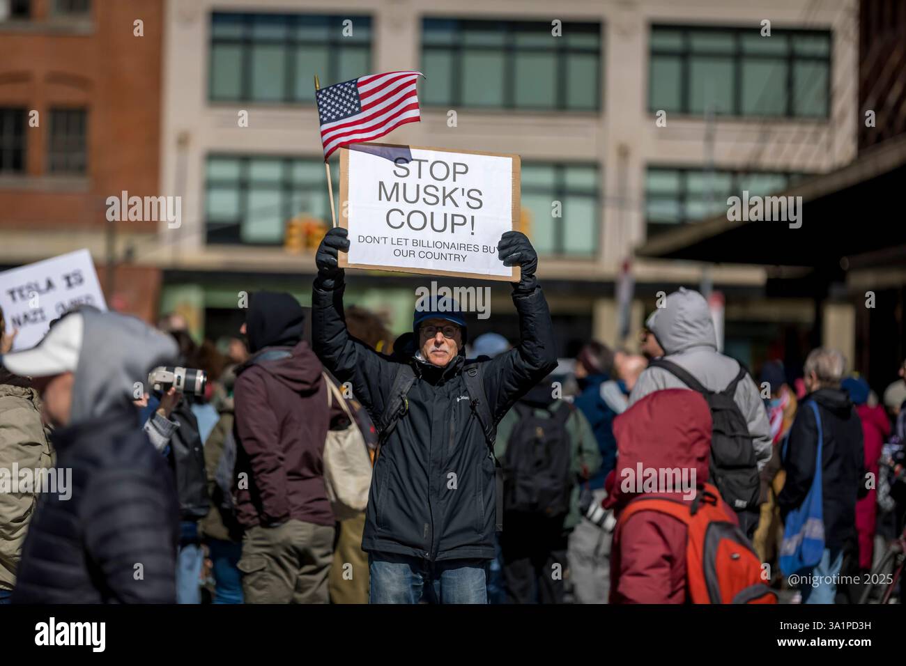 New York, United States. 08th Mar, 2025. A protestor outside a Tesla ...