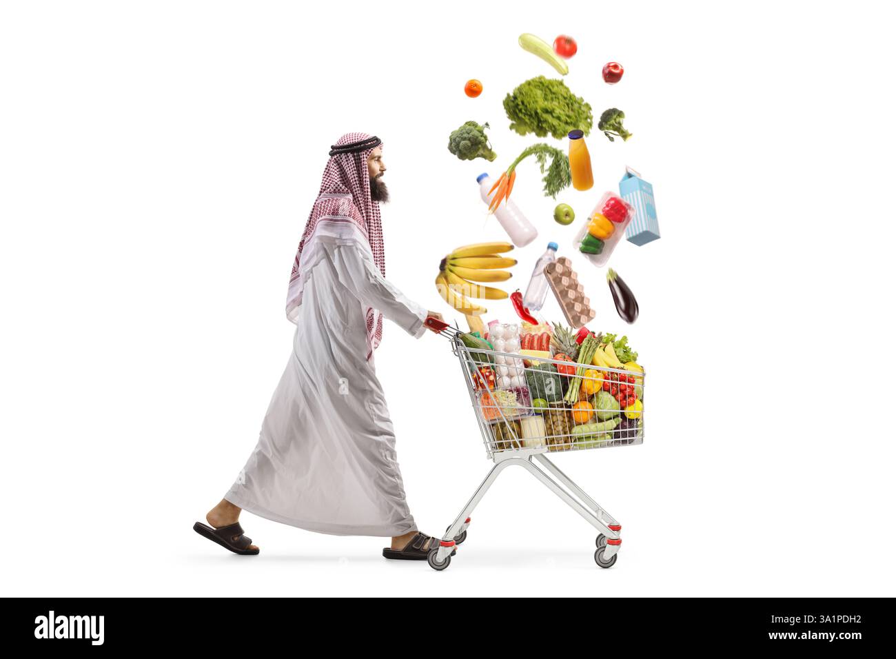 Full length profile shot of a saudi arab man walking and pushing a ...