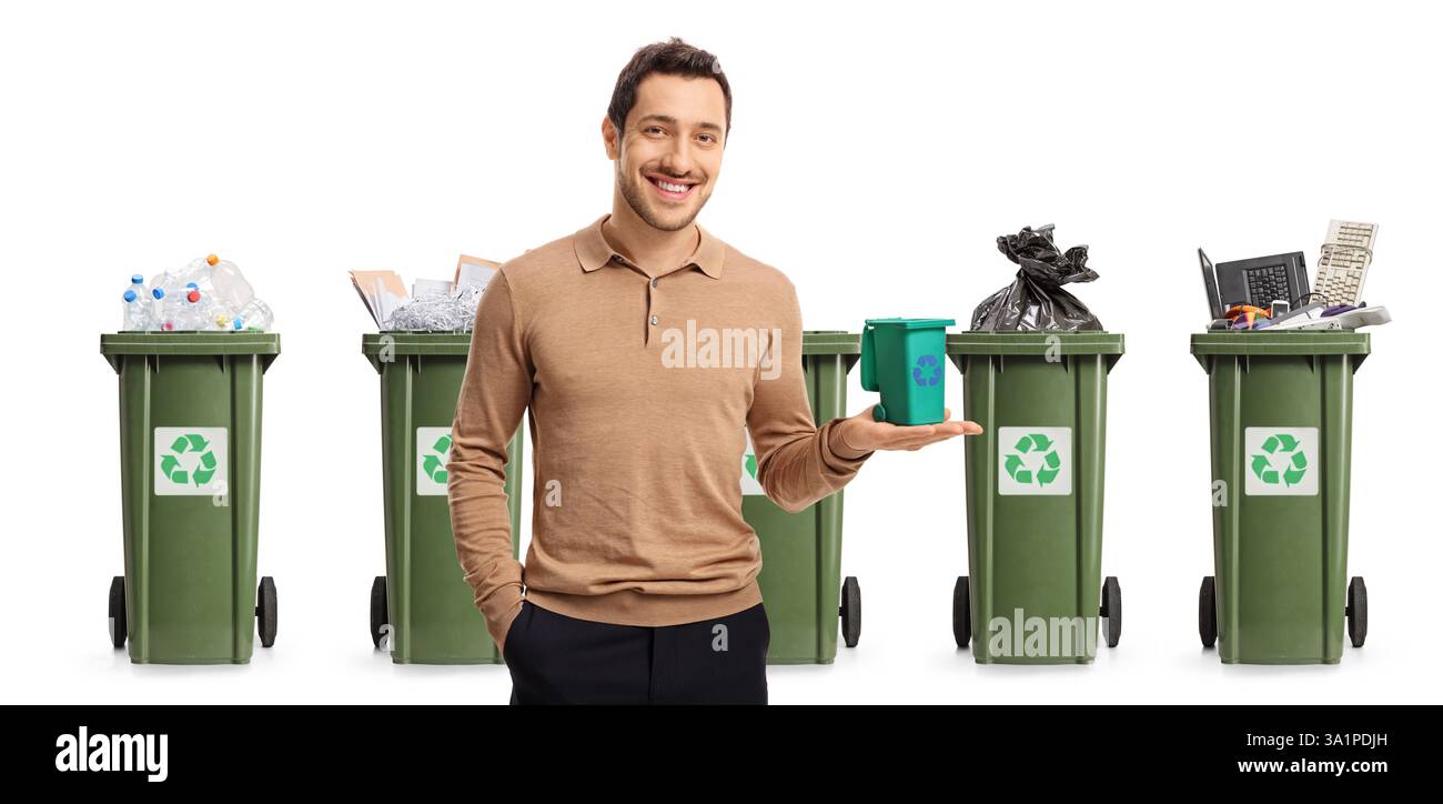 Young guy holding a small bin as a symbol for recycling waste materials ...