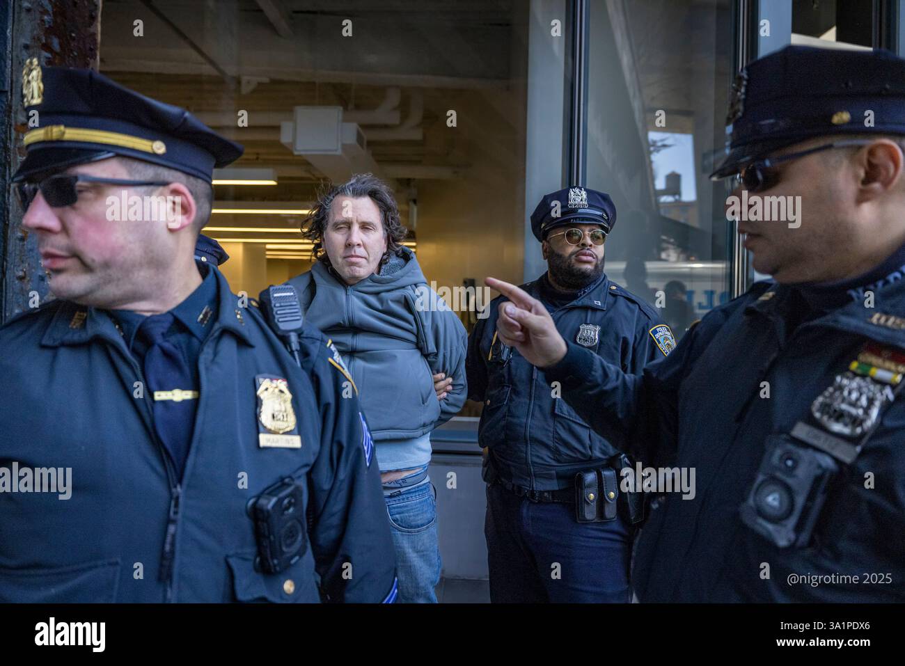 New York, New York, USA. 8th Mar, 2025. An arrested protestor waits ...