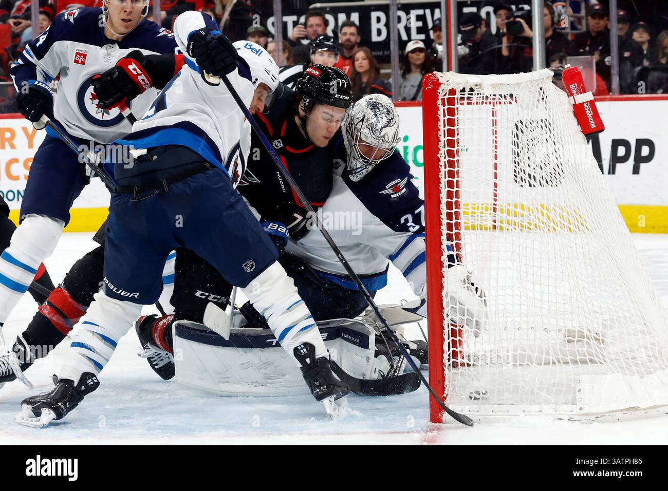 Carolina Hurricanes' Mark Jankowski (77) pushes the puck past Winnipeg ...