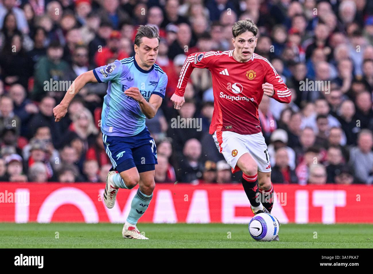 MANCHESTER, ENGLAND - MARCH 09: Alejandro Garnacho of Manchester United and Leandro Trossard of ...