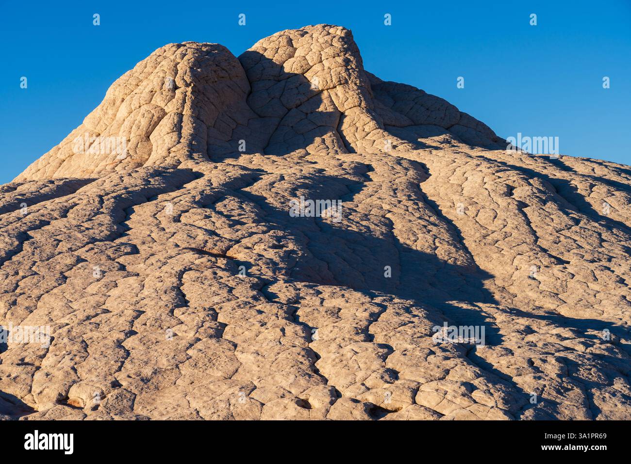 Intricate geological formations tower under a clear blue sky at White ...