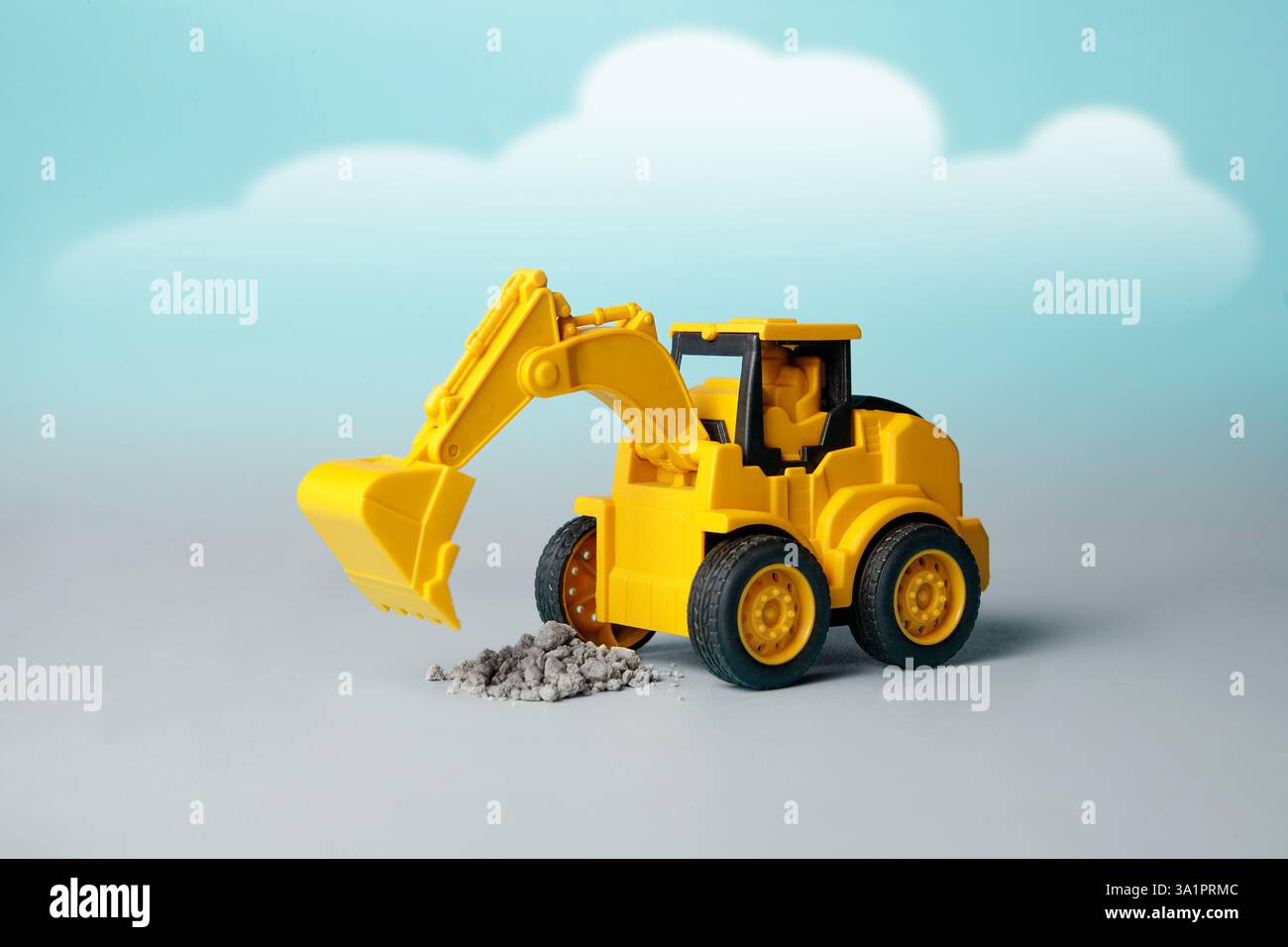 yellow mini excavator toy is digging up debris Stock Photo - Alamy