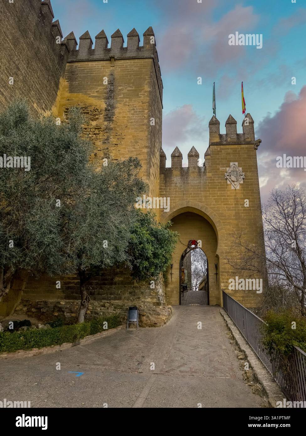 Ornamented castle gate at Almodovar with sunset cloudy sky background ...
