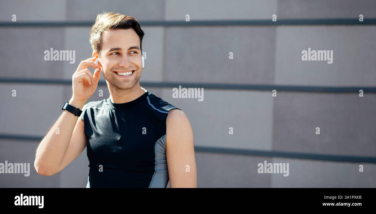 Great mood and sport. Smiling guy in sportswear with fitness tracker ...