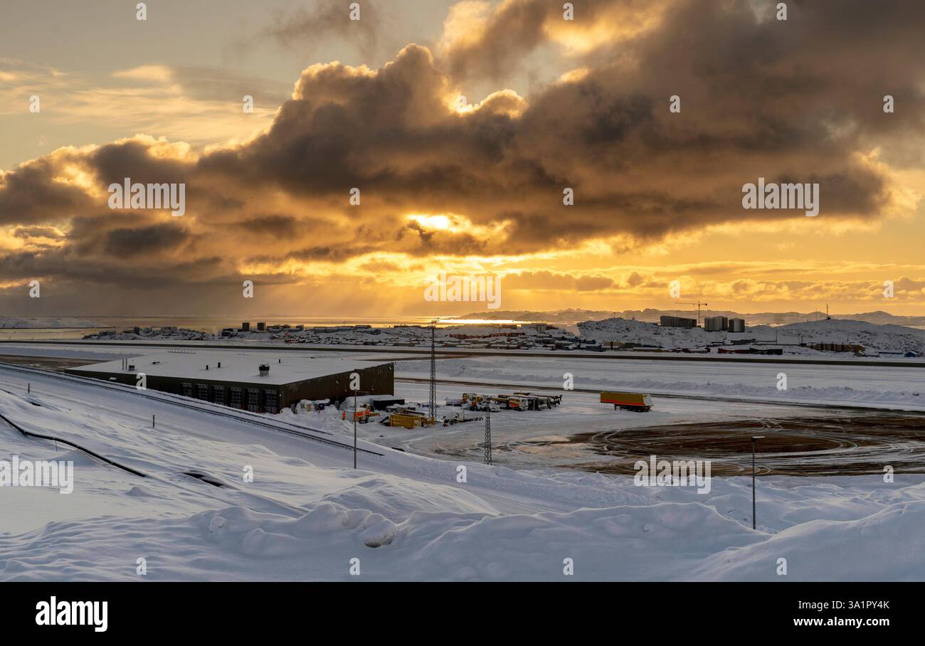 A scenic winter landscape featuring a snowy airport runway under a ...