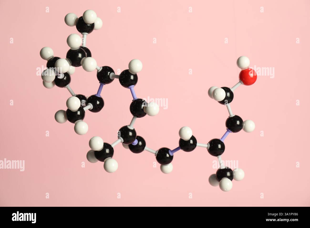 Molecule of retinol (vitamin A) on pink background. Chemical model ...