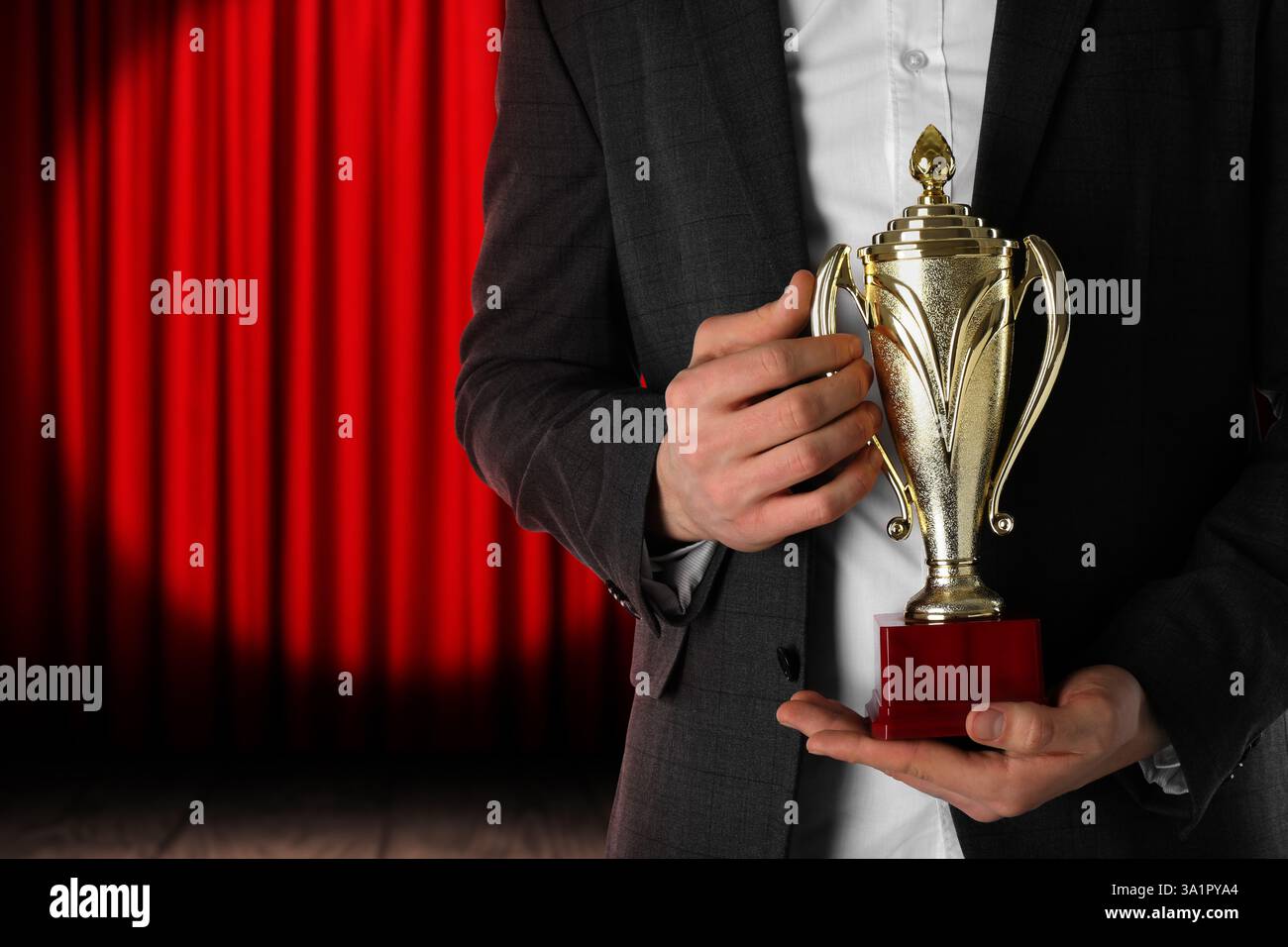 Man holding golden trophy hi-res stock photography and images - Alamy