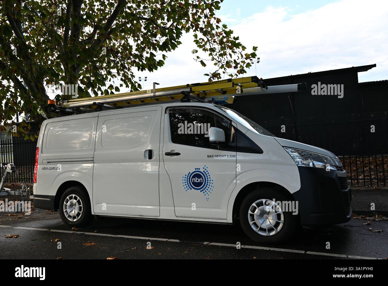 Side view of a parked National Broadband Network van, a white Toyota ...