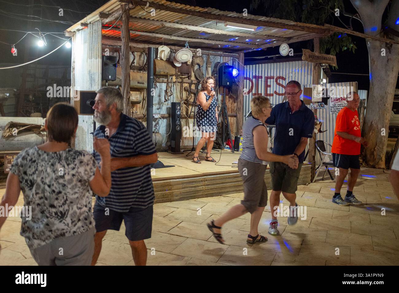 Grey nomad retirees travelling around Australia dancing at the outback ...