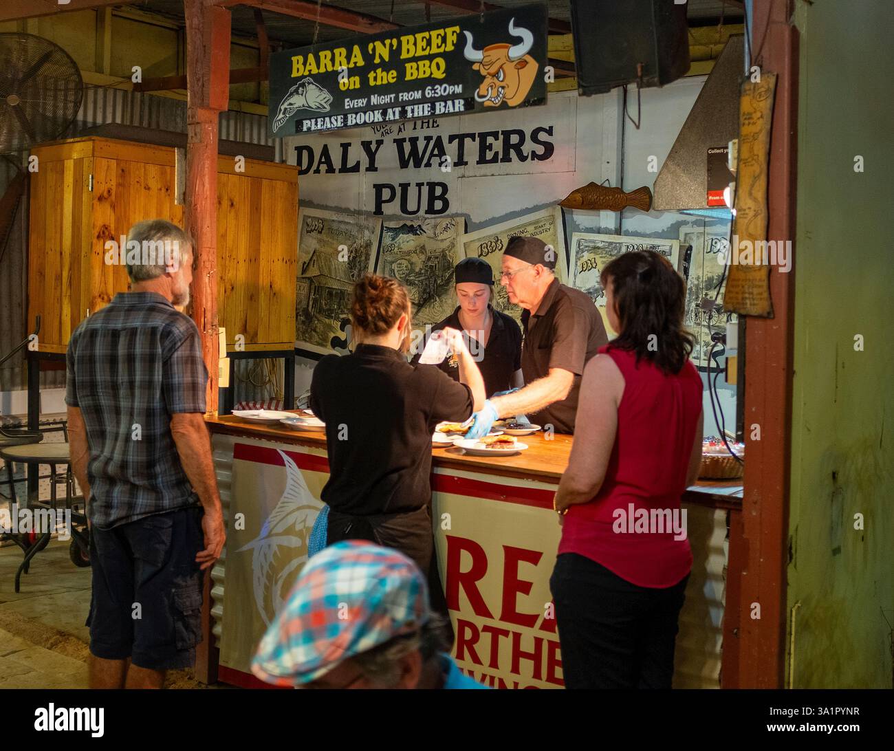 Kitchen staff serving customers of the Daly Waters Pub in Australia's ...