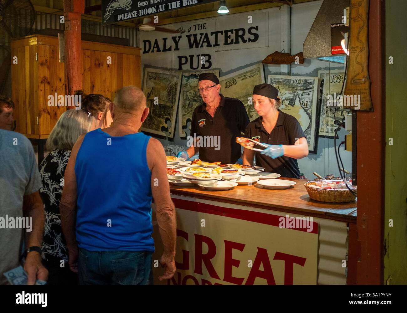 Kitchen staff serving customers of the Daly Waters Pub in Australia's ...