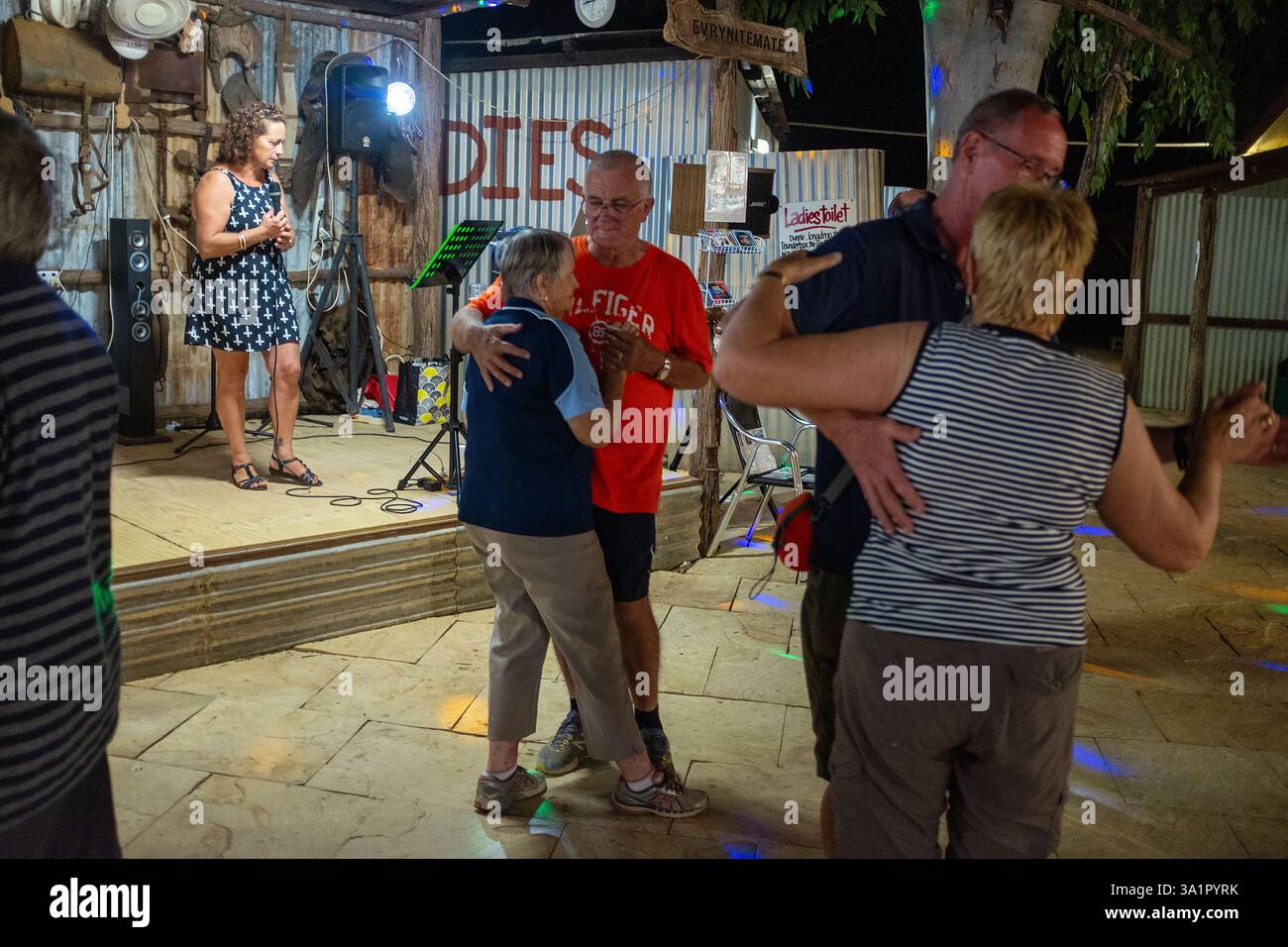 Grey nomad retirees travelling around Australia dancing at the outback ...