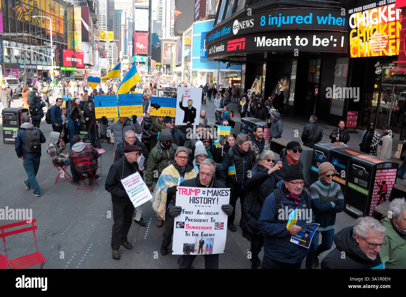Pro-Ukraine demonstrators march holding placards in Times Square ...