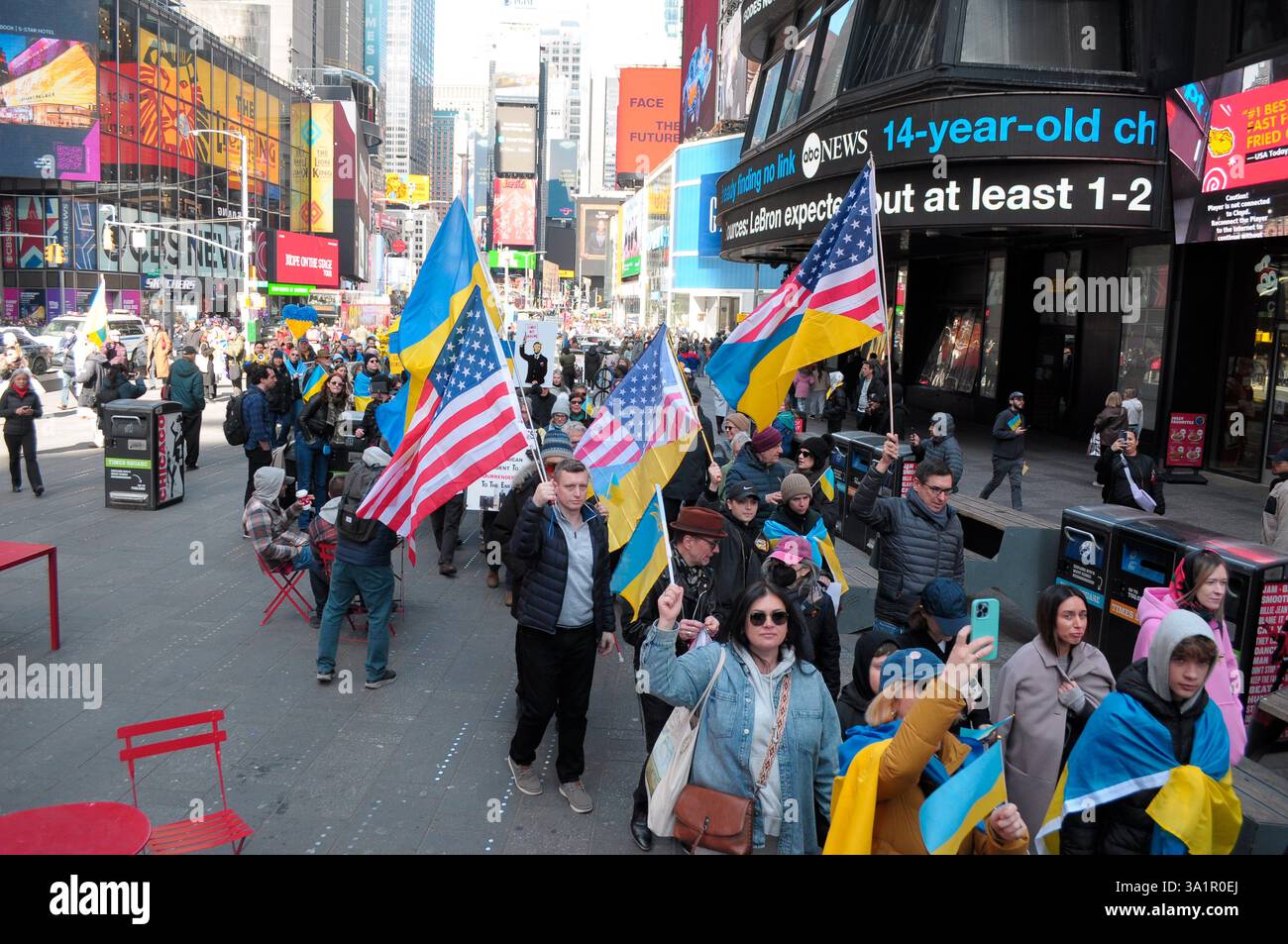 Pro-Ukraine demonstrators march holding Ukrainian and American flags in ...