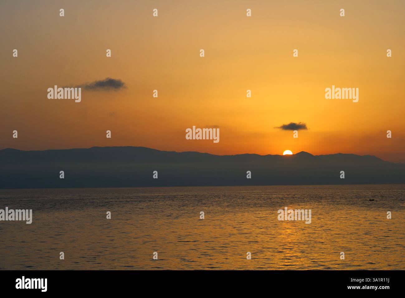Early morning pink glow sunrise overlooking waterfront in Corfu Town ...