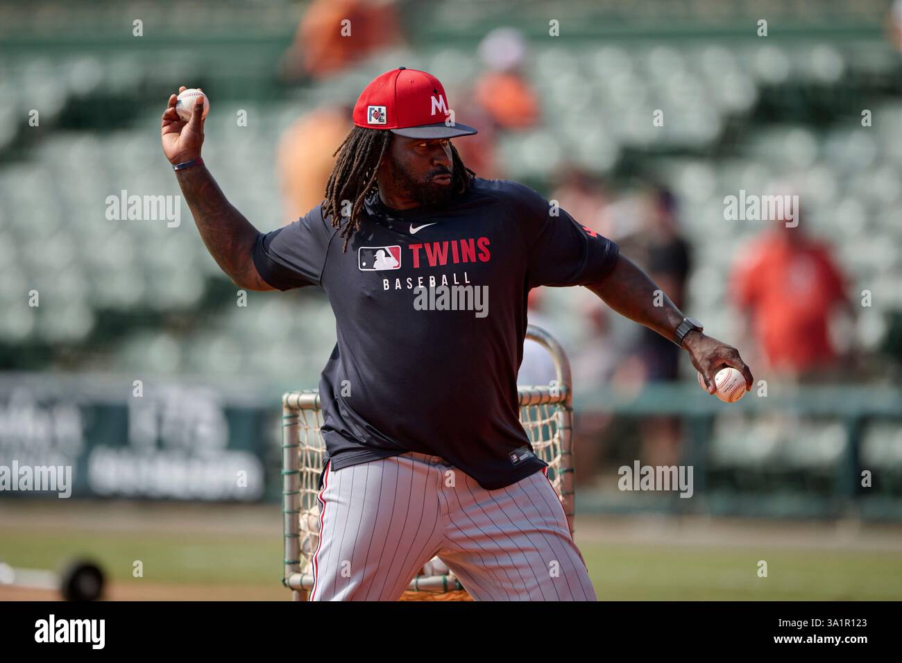 Minnesota Twins coach Tommy Watkins (40) throws batting practice before ...