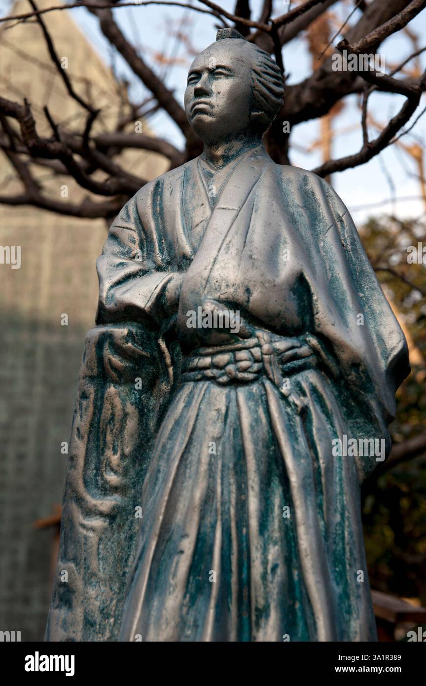 Bronze statue of samurai Sakamoto Ryoma standing in the garden at Teradaya Inn showing his ...