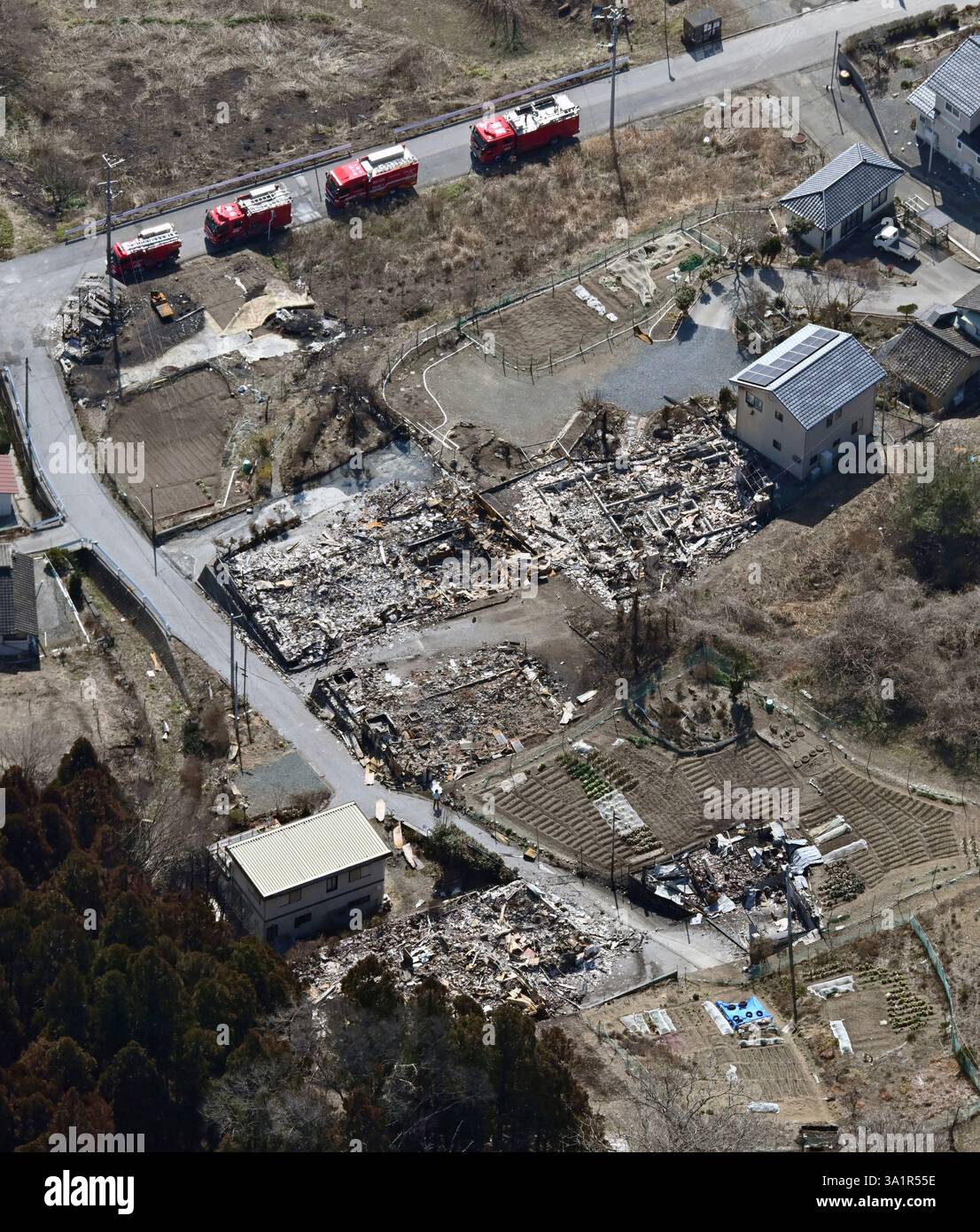 Aerial photograph shows houses damaged by forest fires in Ofunato ...