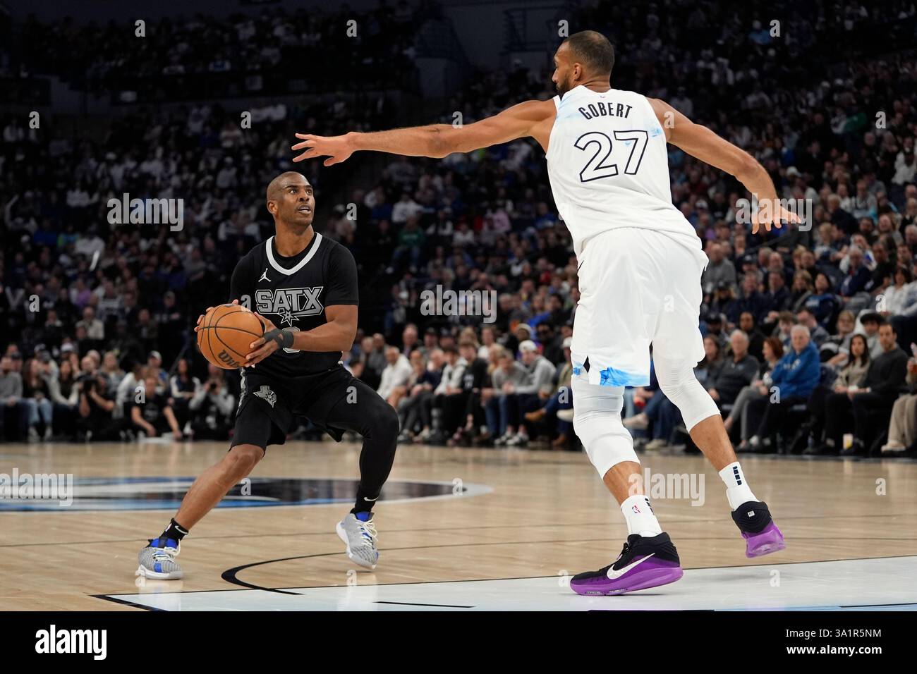 San Antonio Spurs guard Chris Paul (3) looks to shoot over Minnesota Timberwolves center Rudy ...
