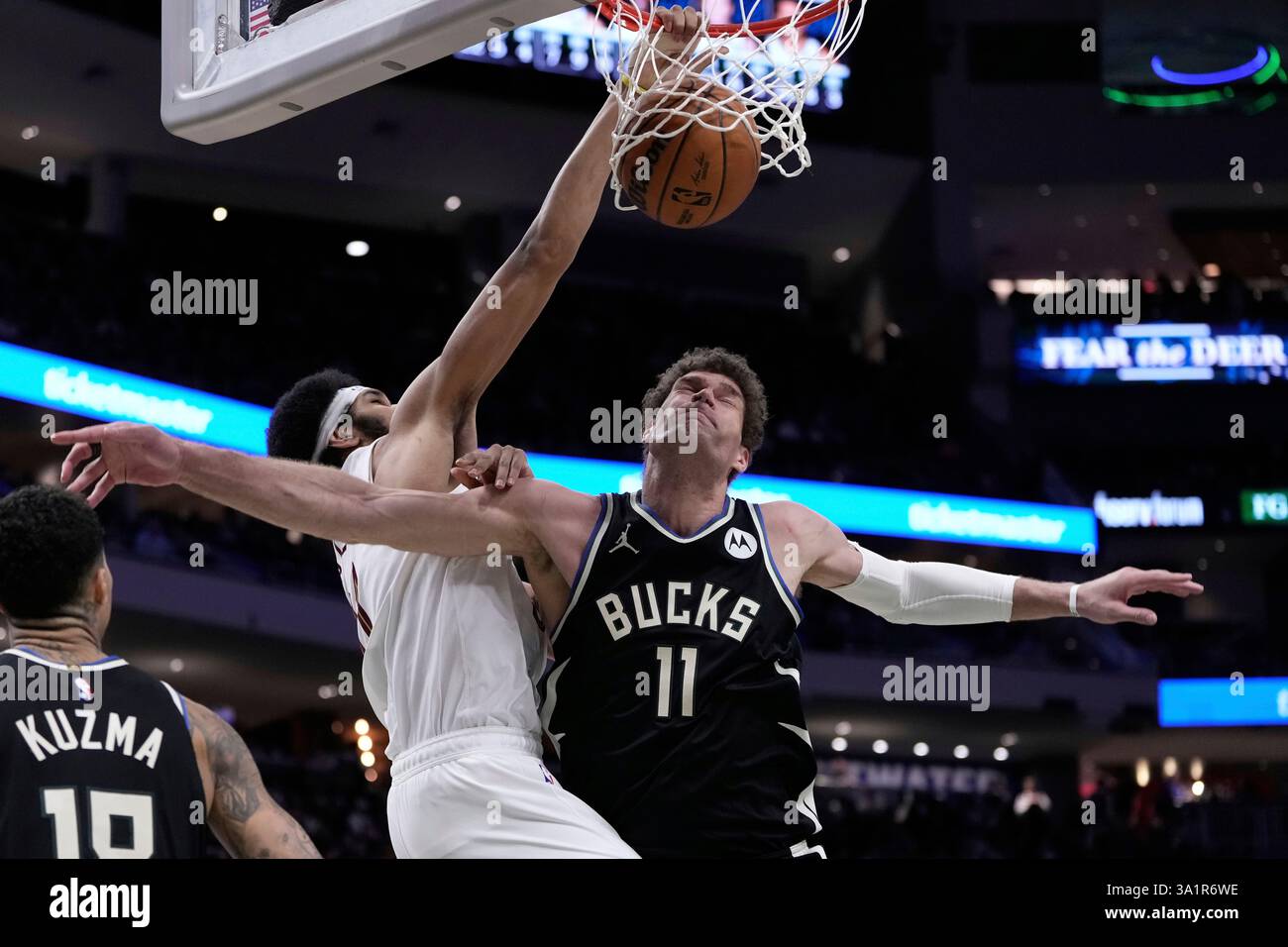 Cleveland Cavaliers' Jarrett Allen dunks over Milwaukee Bucks' Brook ...