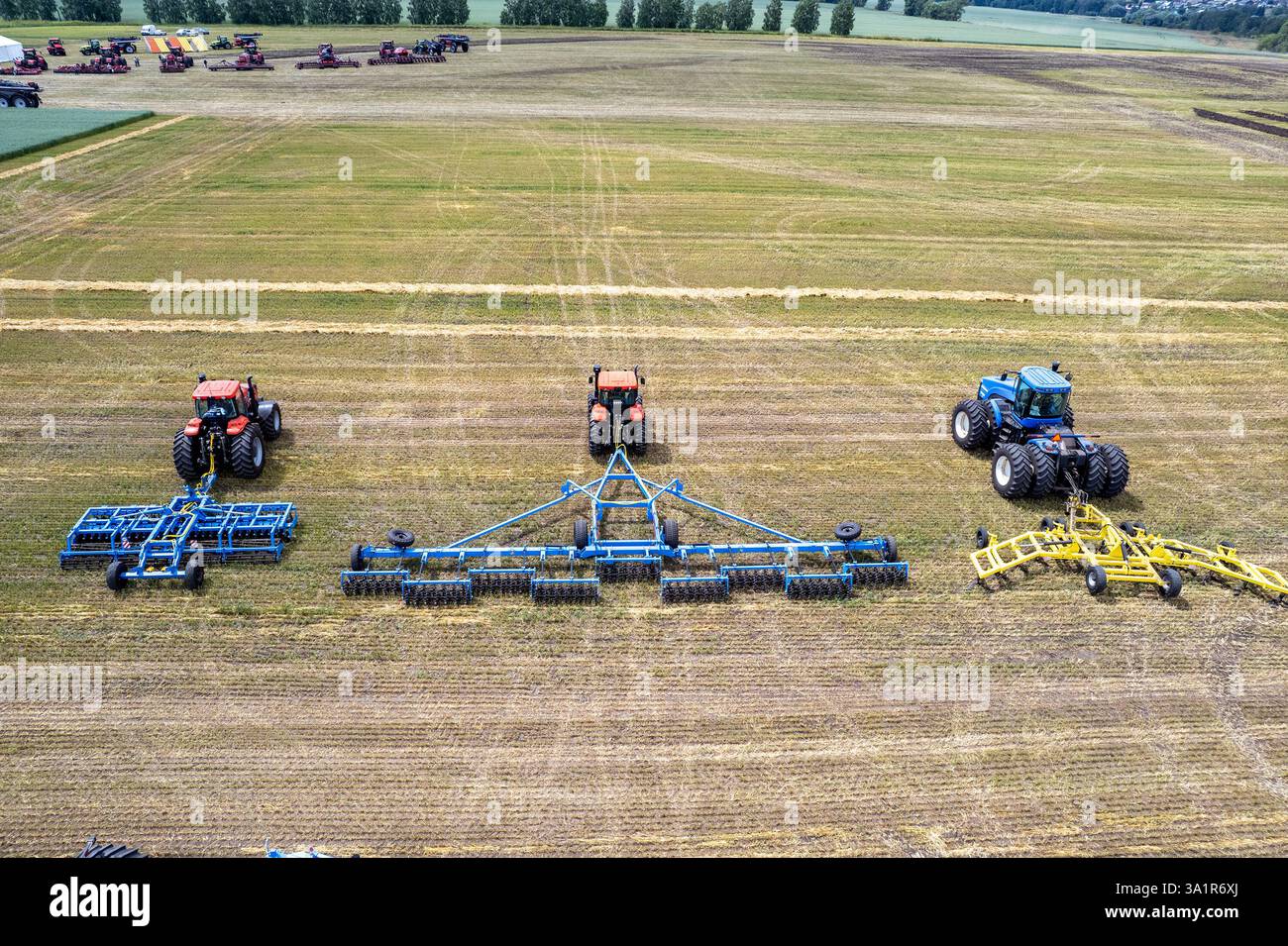 Aerial view of agricultural tractor doing stubble field fall tillage on ...
