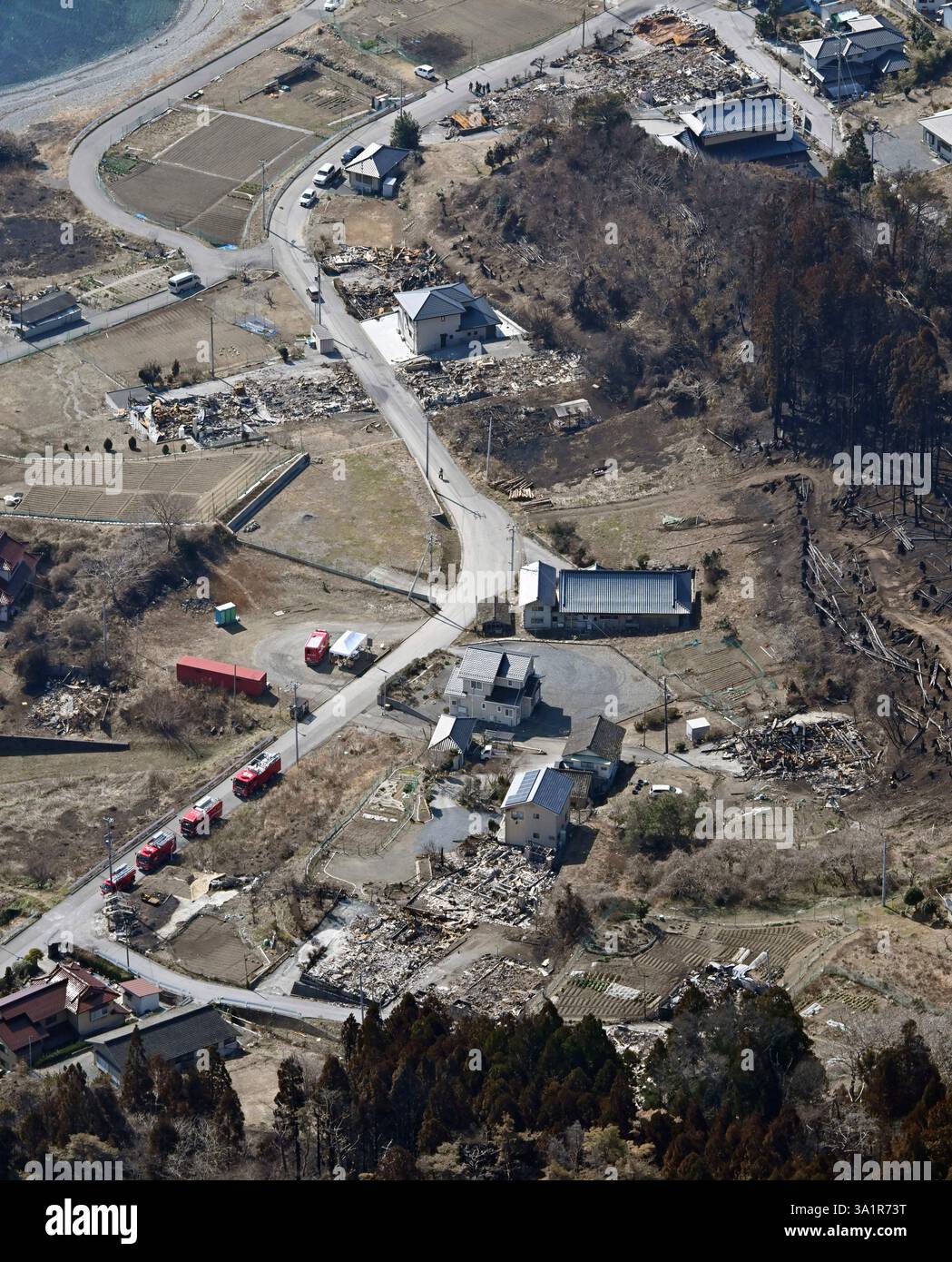 Aerial photograph shows houses damaged by forest fires in Ofunato ...