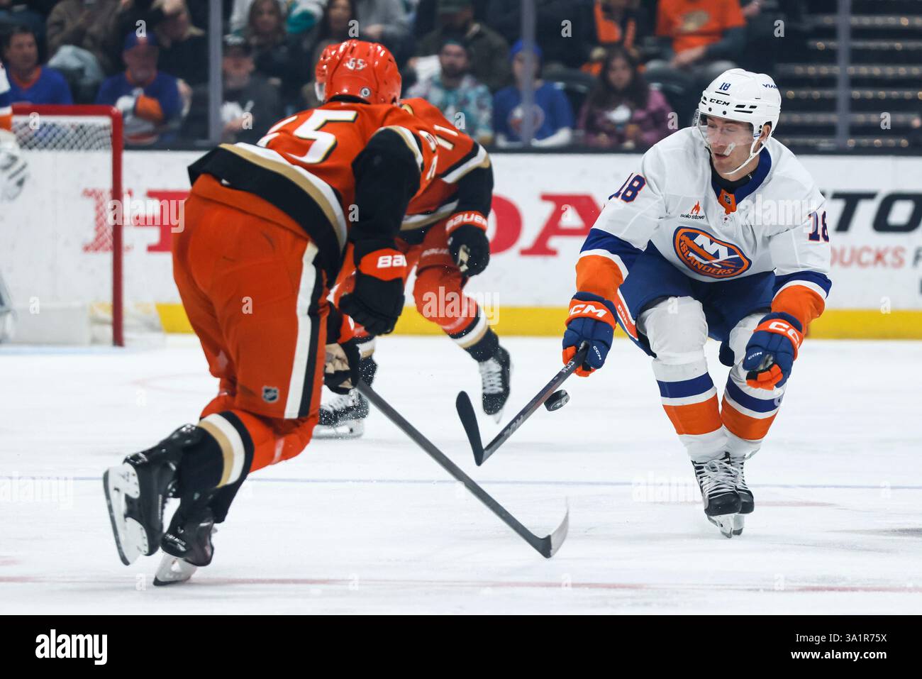 New York Islanders winger Pierre Engvall, right, controls the puck away ...