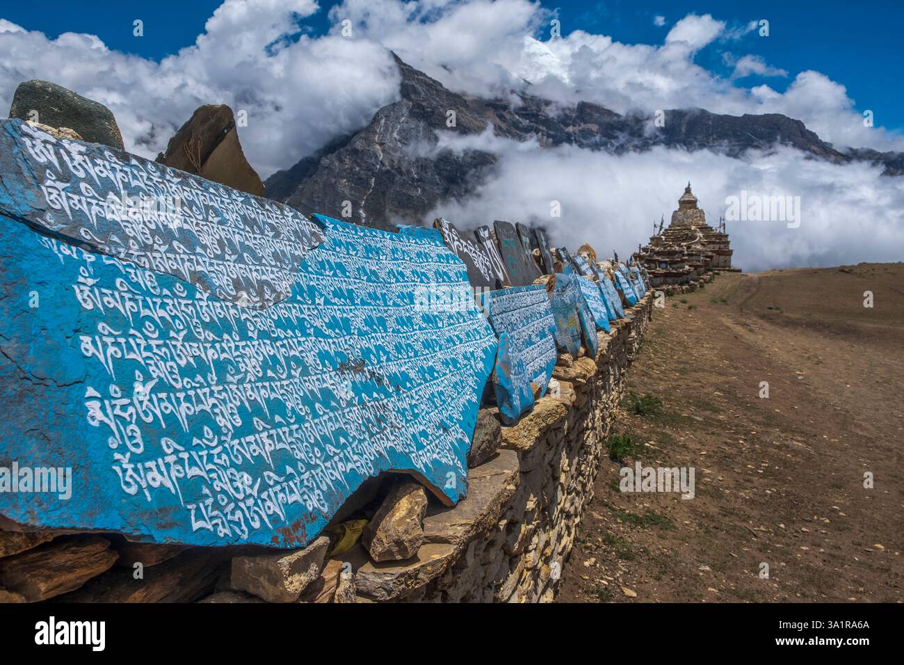 Sacred stones inscribed with mantras form a Mani wall near Nar, Nepal ...