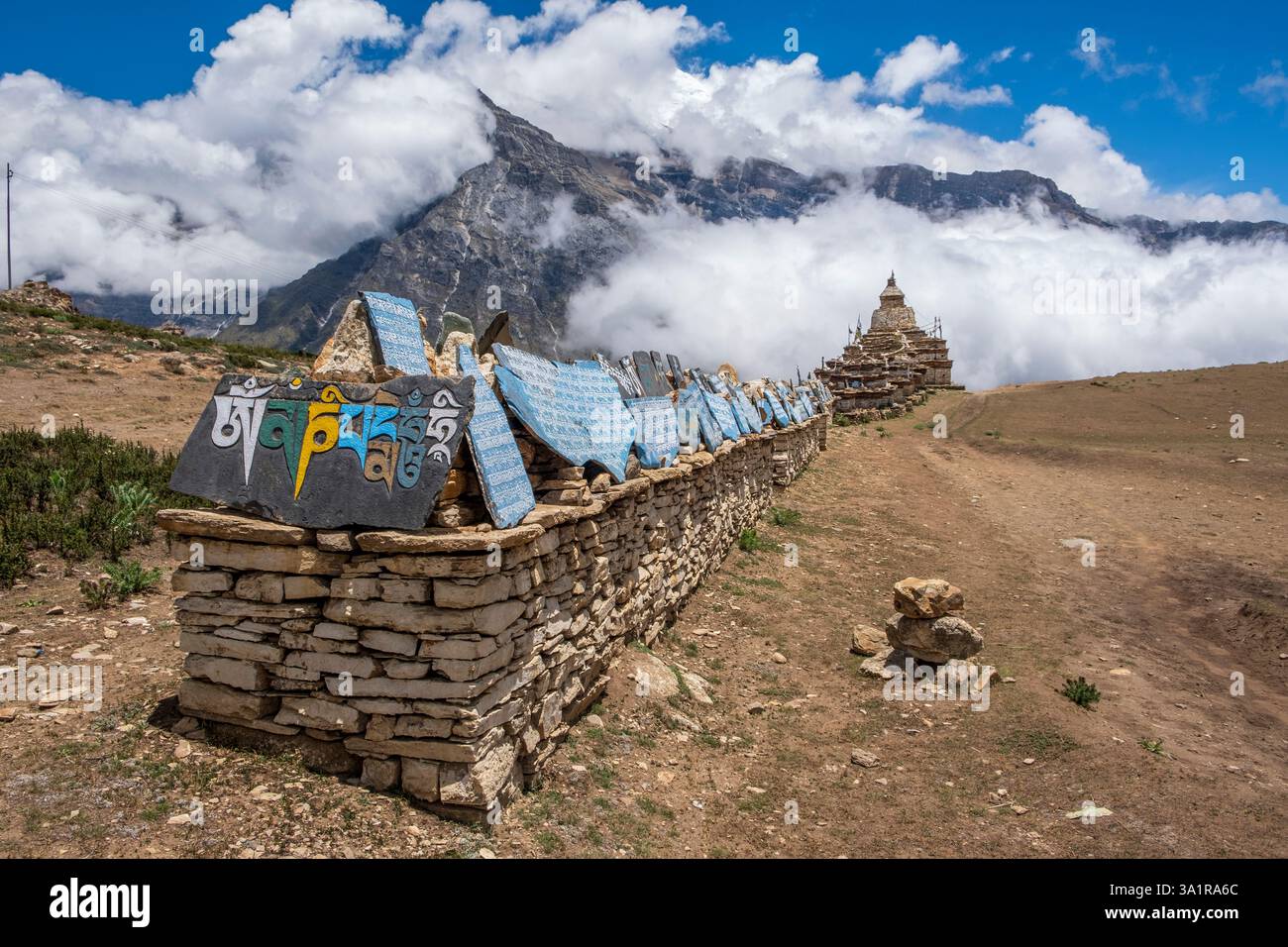 Sacred stones inscribed with mantras form a Mani wall near Nar, Nepal ...
