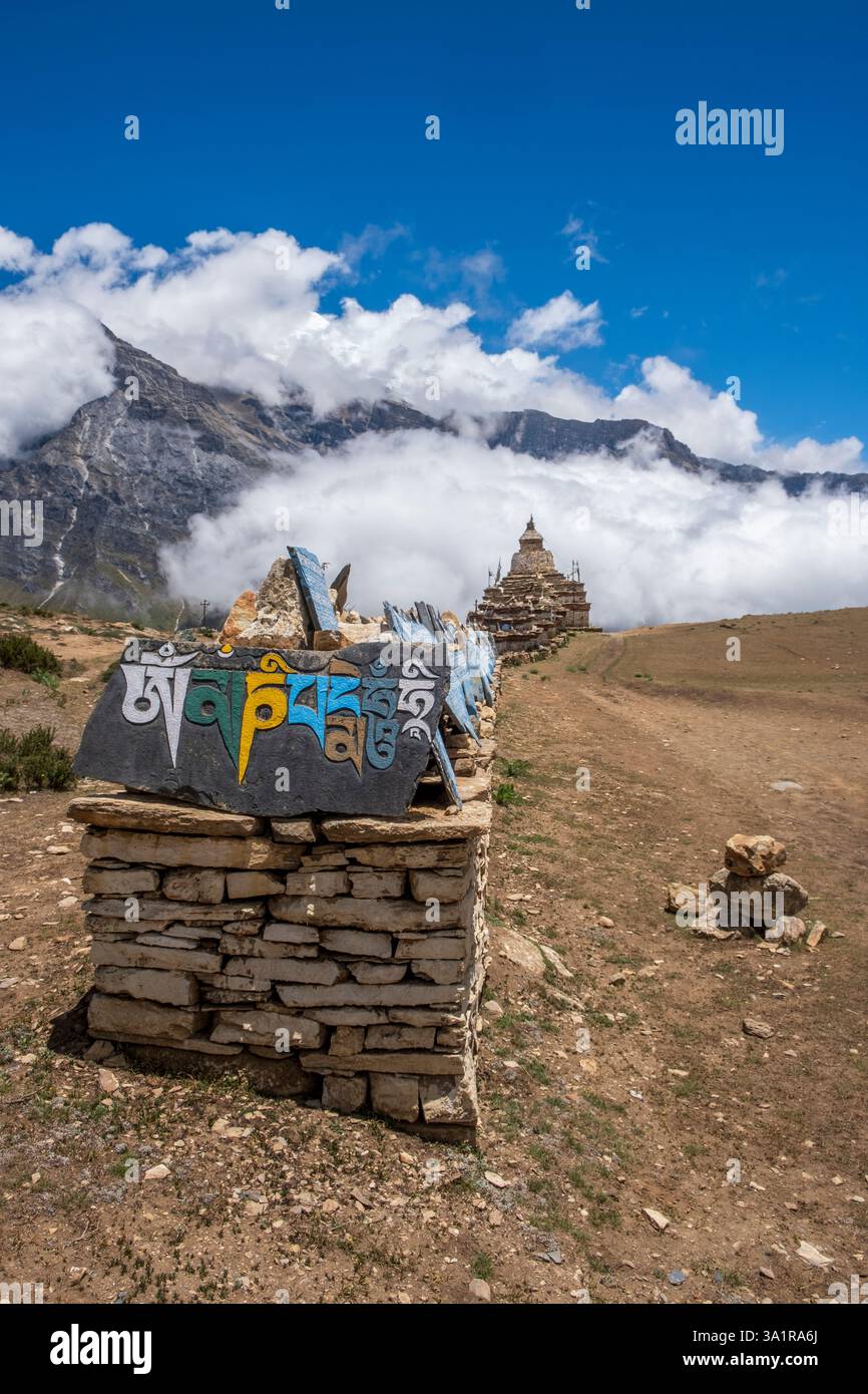 Sacred stones inscribed with mantras form a Mani wall near Nar, Nepal ...