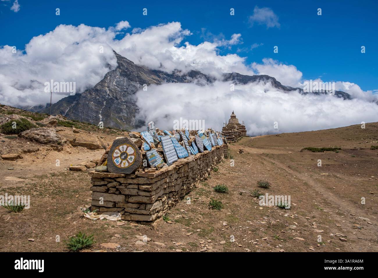 Sacred stones inscribed with mantras form a Mani wall near Nar, Nepal ...