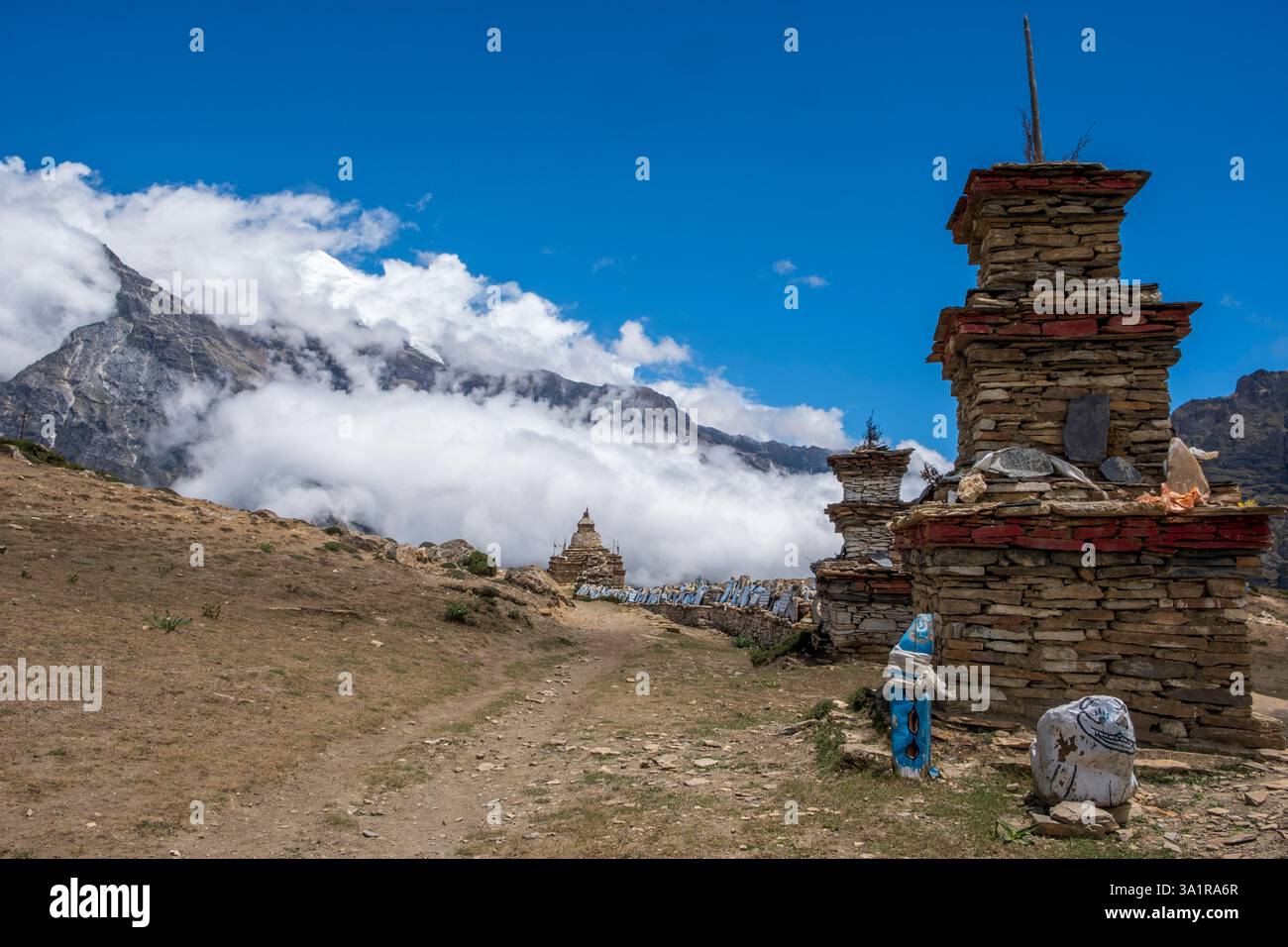 Sacred stones inscribed with mantras form a Mani wall near Nar, Nepal ...