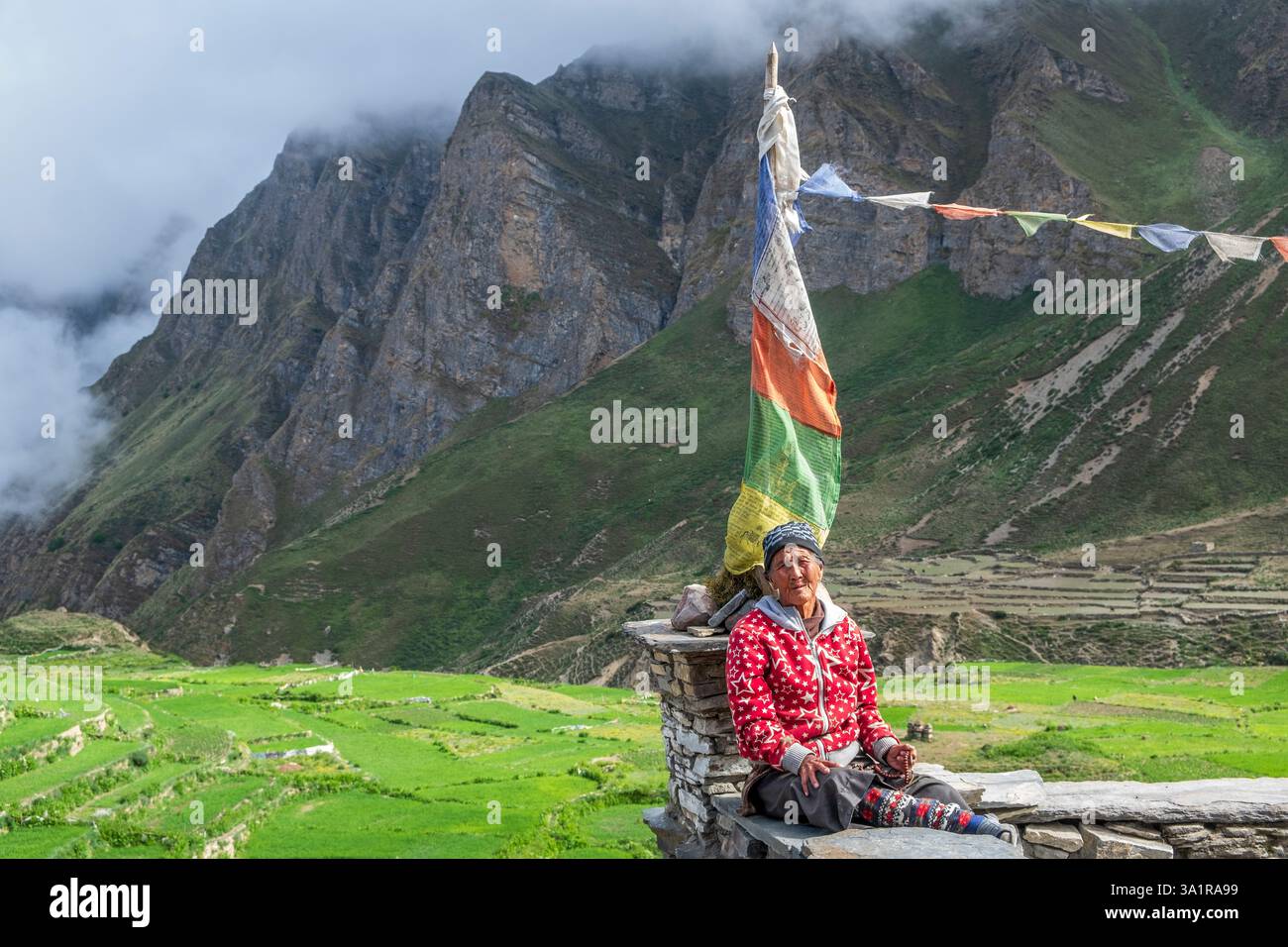 An elderly woman poses in Nar village, one of the restricted areas in ...
